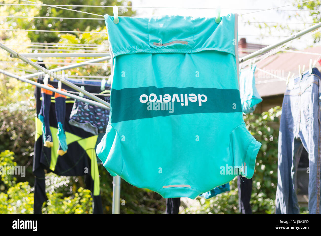 Deliveroo rider's uniform on washing line, UK Stock Photo - Alamy