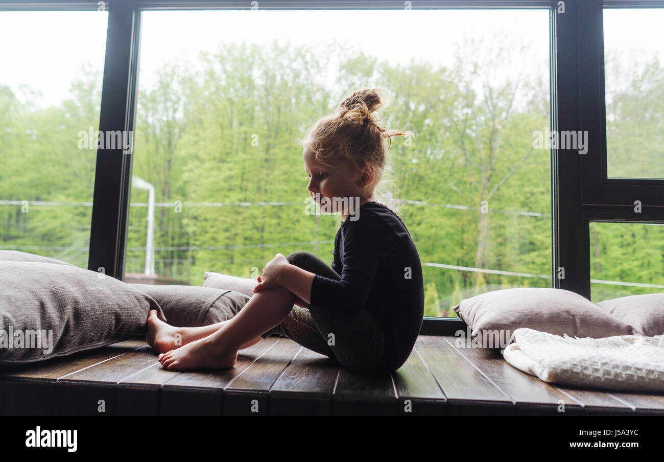 Little girl on the background of a large window Stock Photo - Alamy