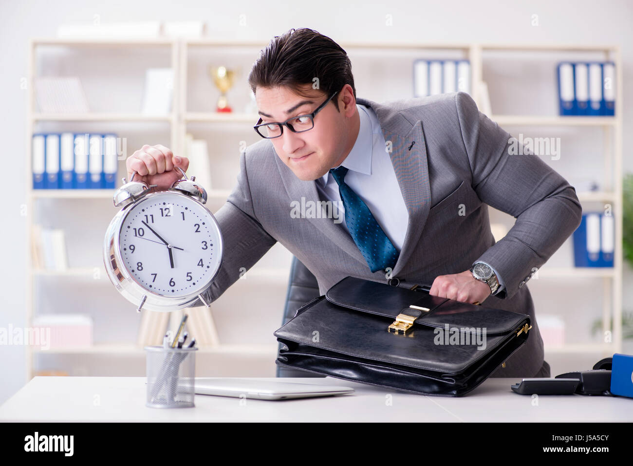 Businessman rushing in the office Stock Photo - Alamy