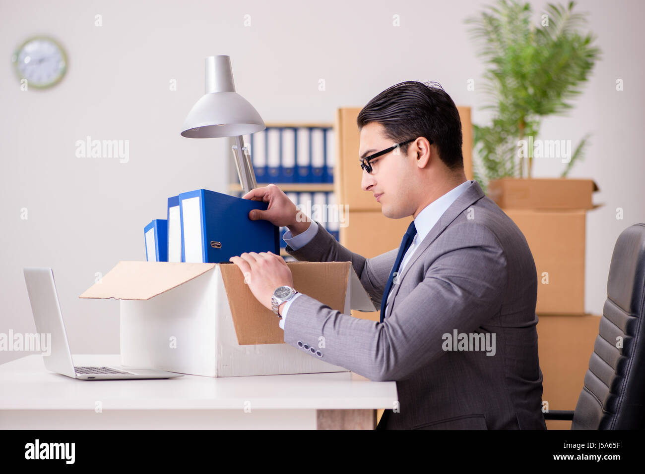 Young handsome businessman moving offices Stock Photo - Alamy