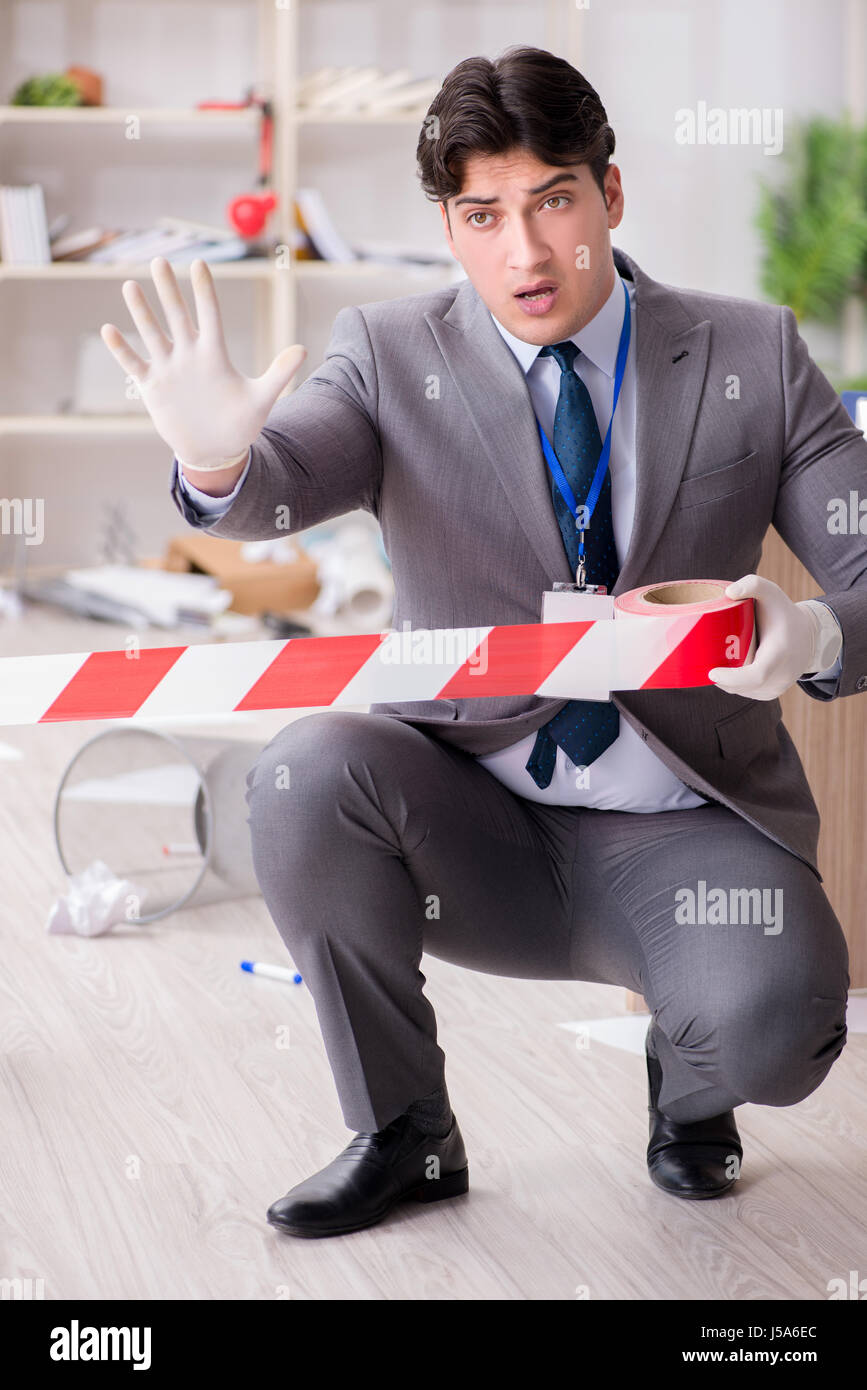 Young man during crime investigation in office Stock Photo - Alamy