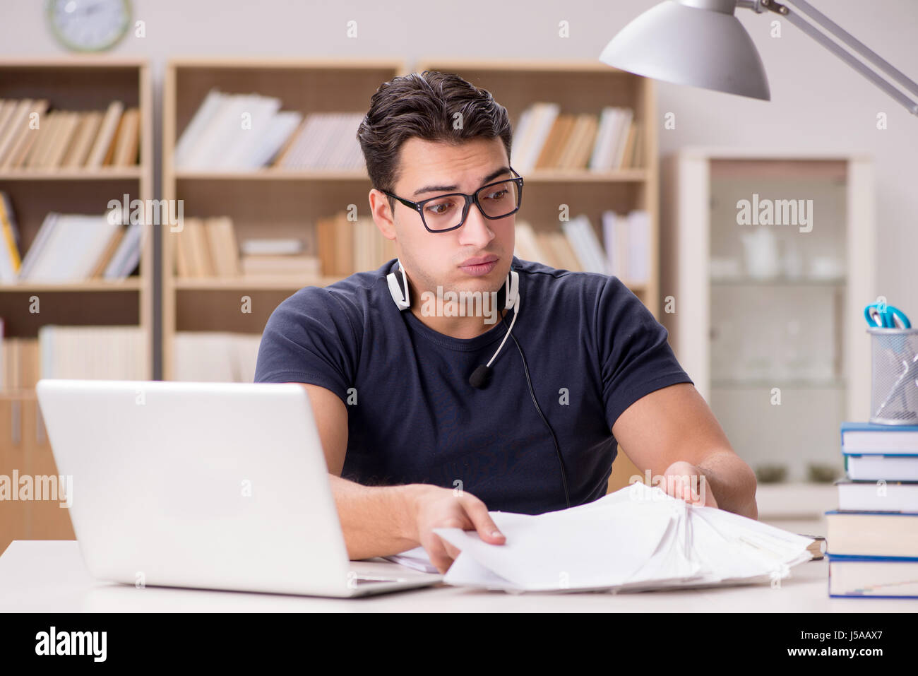 Angry man with too much paperwork to do Stock Photo - Alamy
