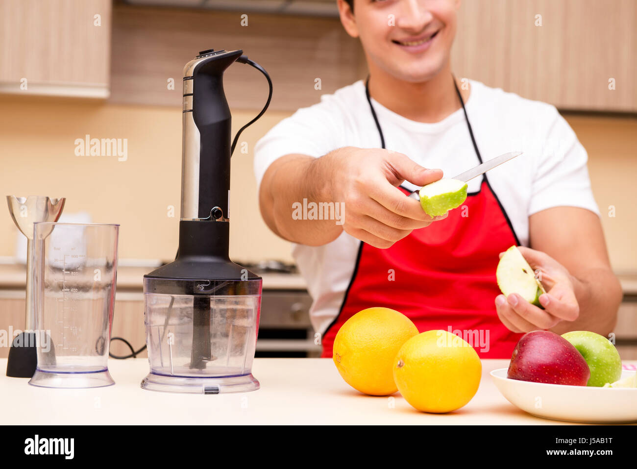 Handsome man working at the kitchen Stock Photo - Alamy