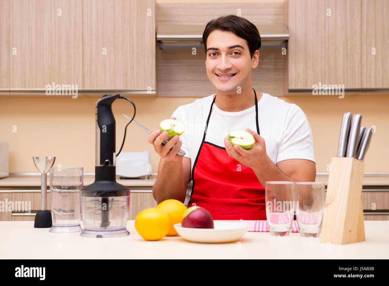 Handsome man working at the kitchen Stock Photo - Alamy