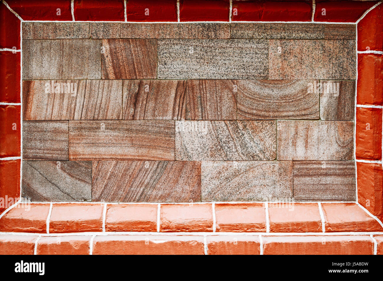 Granite tiles on wall inside frame of bricks Stock Photo - Alamy