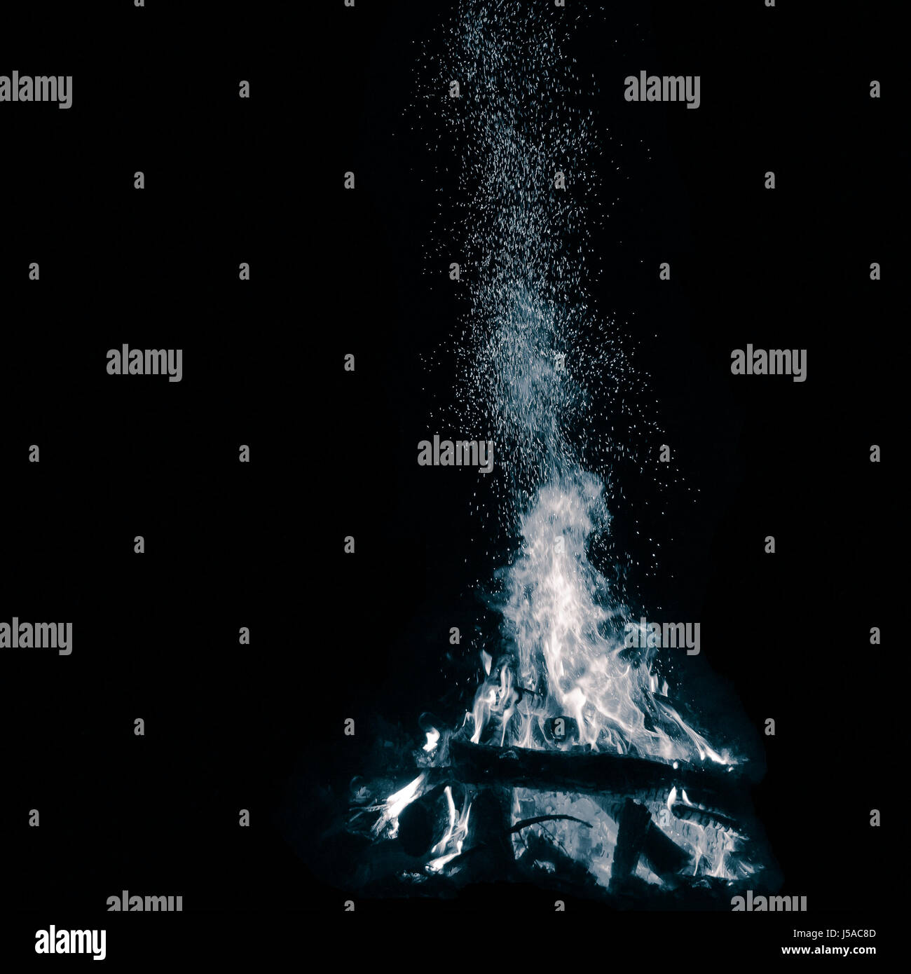 Blue bonfire with flying sparks isolated on black Stock Photo - Alamy