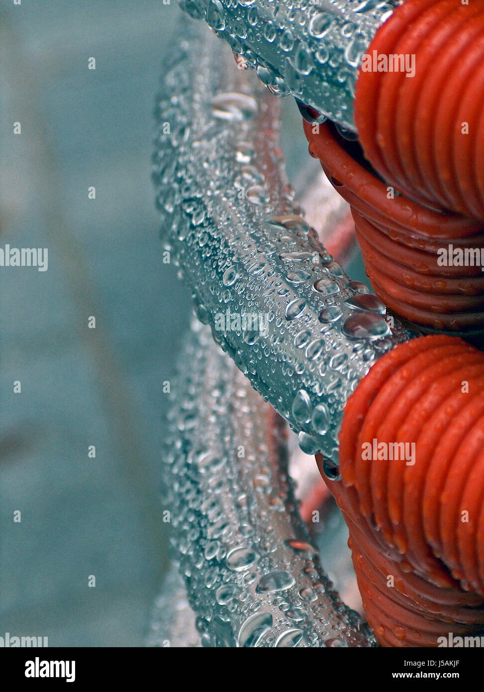 raindrop wet plastic synthetic material flood stacked orange backs of a ...