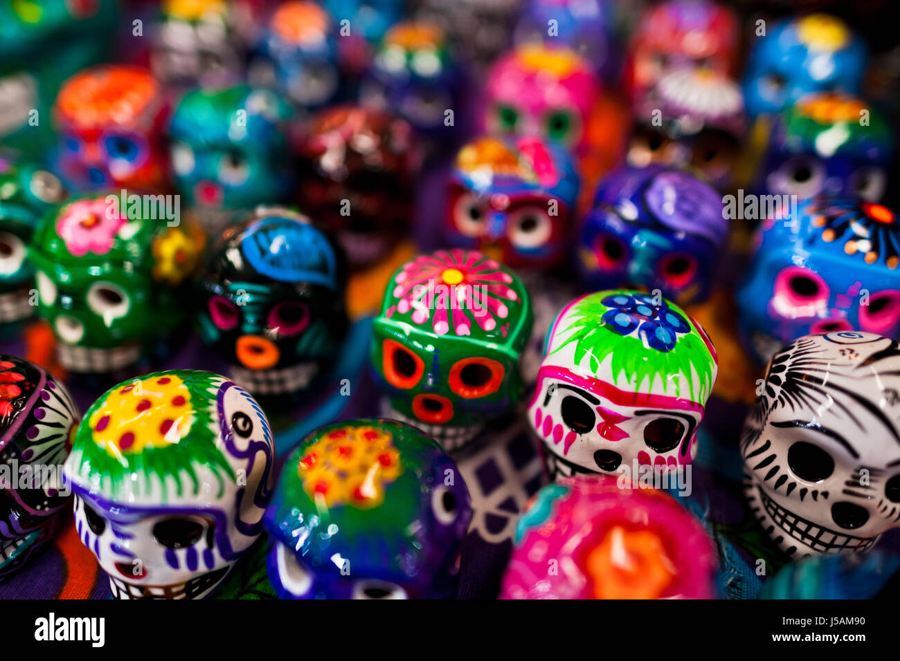 Colorful painted skulls (Calaveras) are sold on the market during the ...