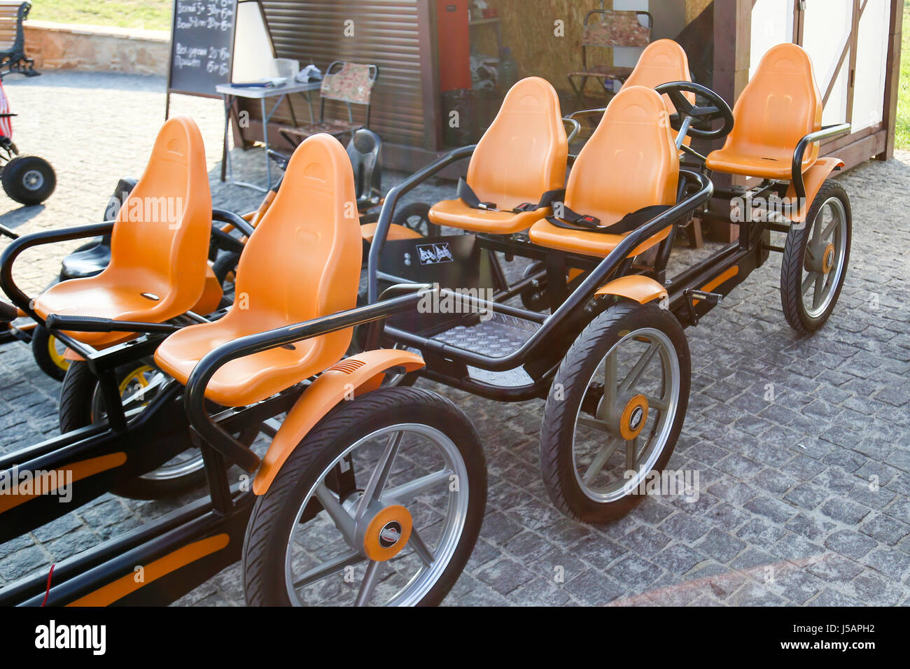 A four seater pedal cart for rent parking Stock Photo - Alamy