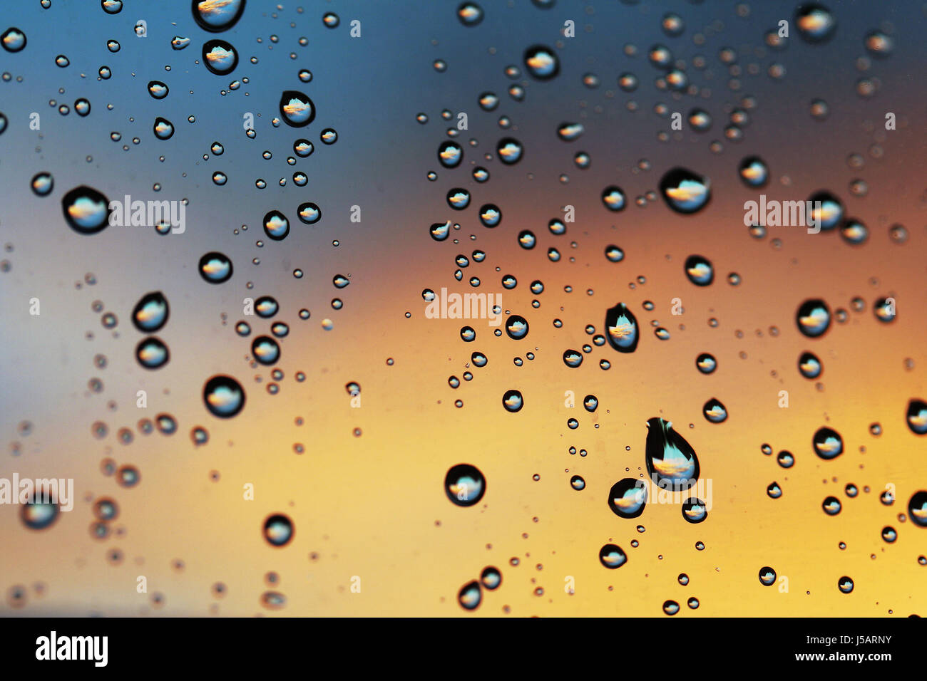 blue window porthole dormer window pane sunset raindrop reflection ...