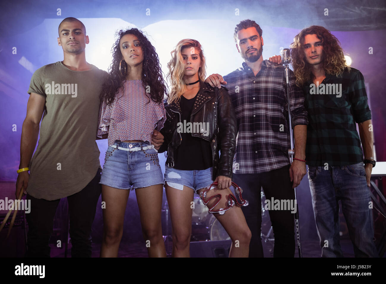 Portrait of musicians standing together at nightclub Stock Photo - Alamy