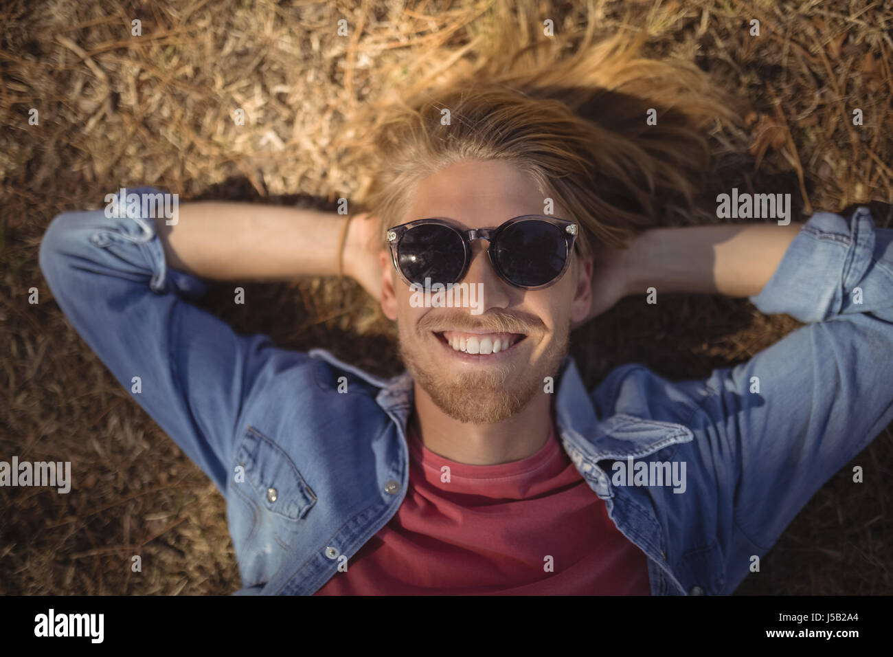 Overhead view of man relaxing on grassy field at forest Stock Photo - Alamy