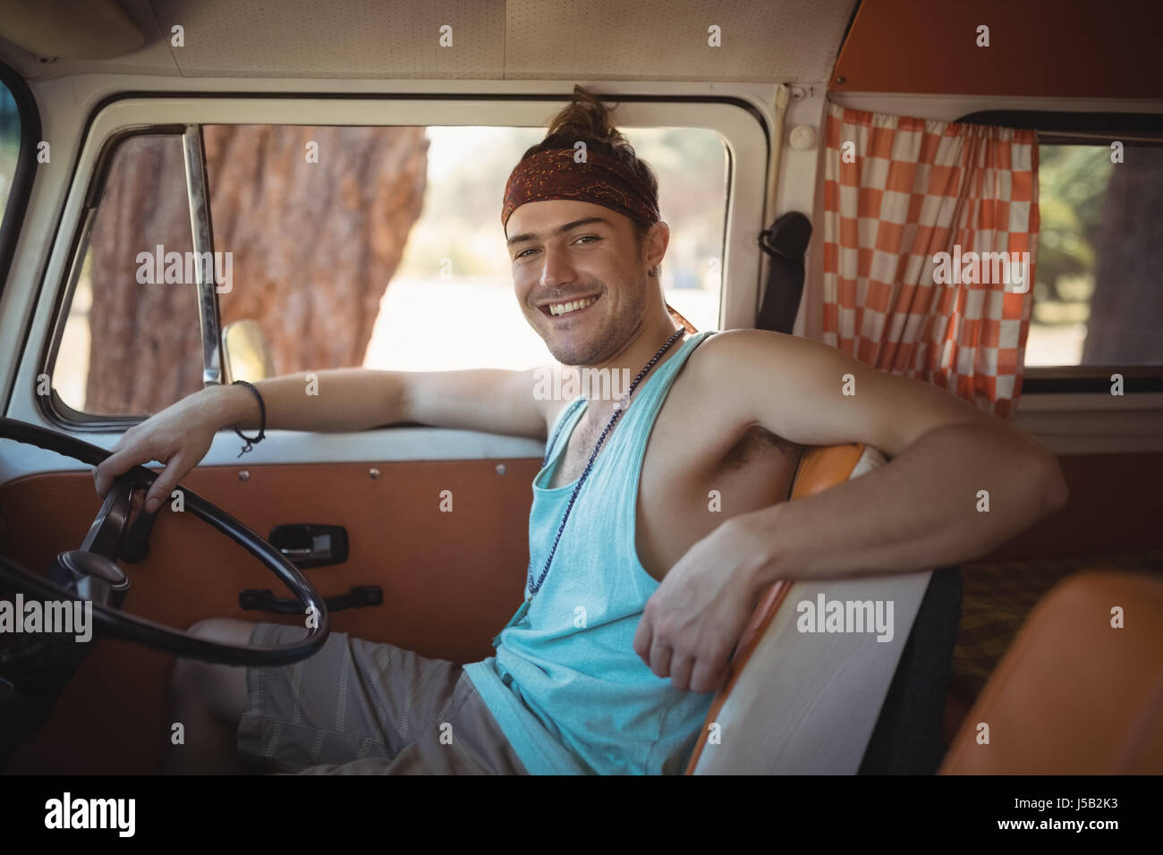 Portrait of smiling young man in mini van Stock Photo - Alamy