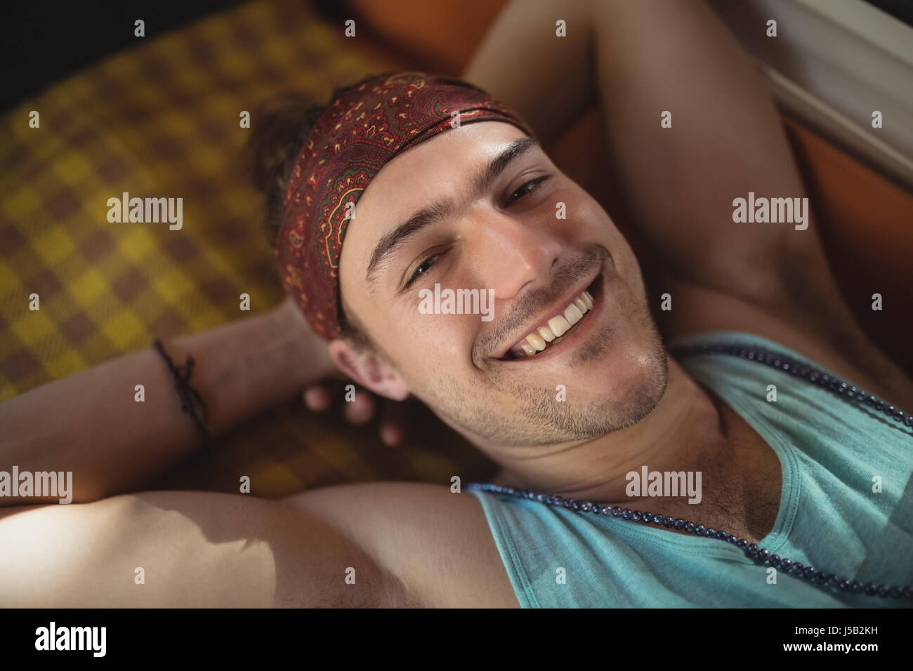 Portrait of happy young man relaxing in mini van Stock Photo - Alamy