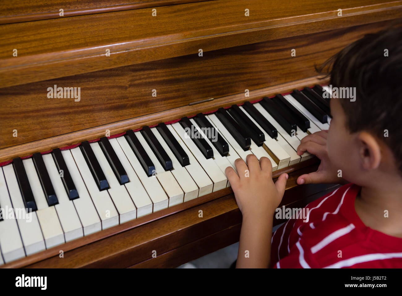 Boy playing piano hi-res stock photography and images - Alamy