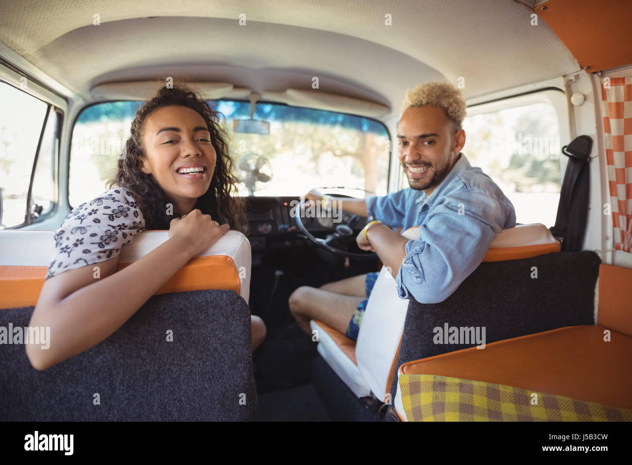 Portrait of joyful friends sitting in mini van Stock Photo - Alamy