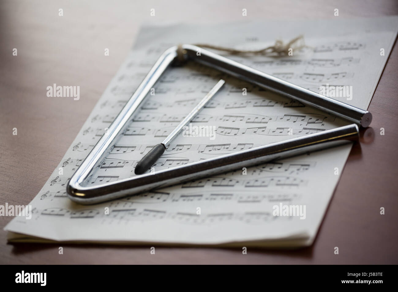 Close up of musical instrument with sheet music on table in classroom ...