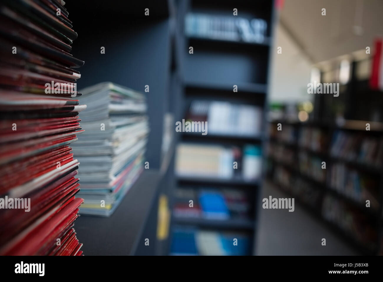 Stack of books on shelf in library at school Stock Photo - Alamy