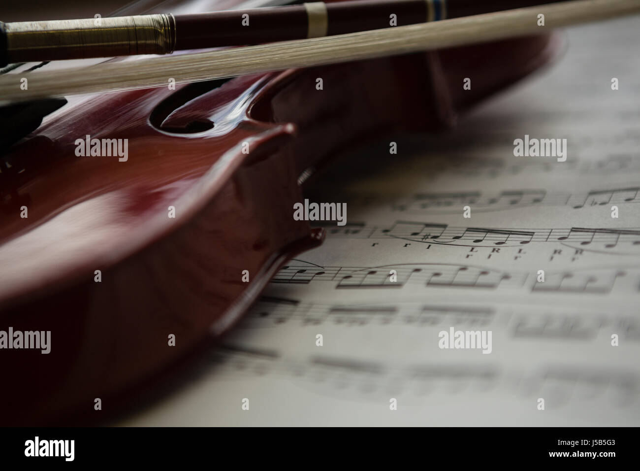 Close up of violin with sheet music on table at classroom Stock Photo ...