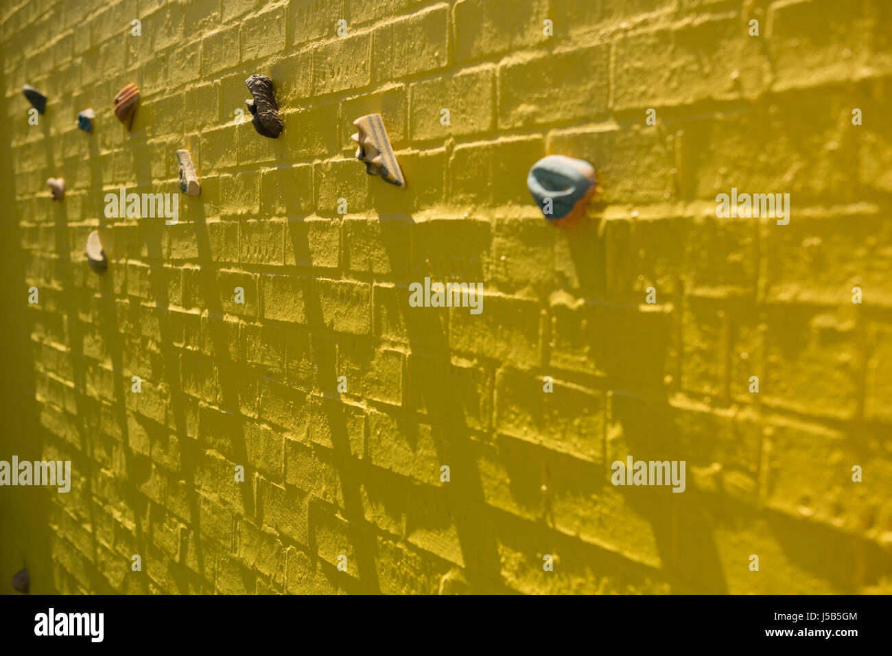 Full frame shot of yellow climbing wall at school Stock Photo - Alamy