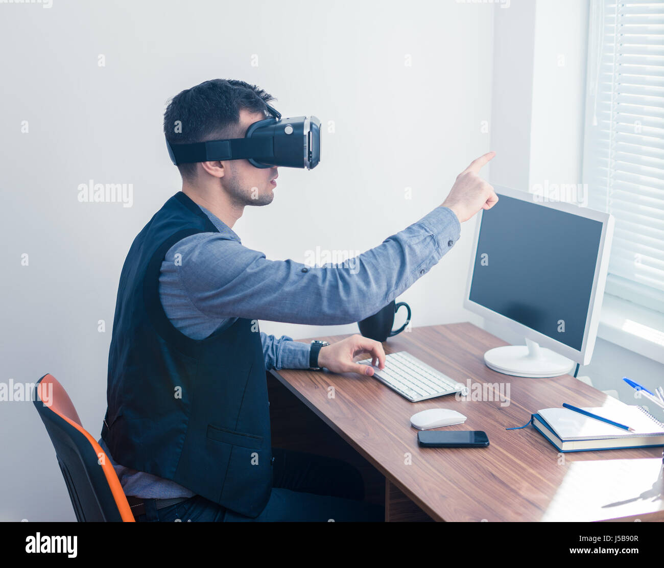 Young businessman in vr glasses drawing chart with gesture Stock Photo ...