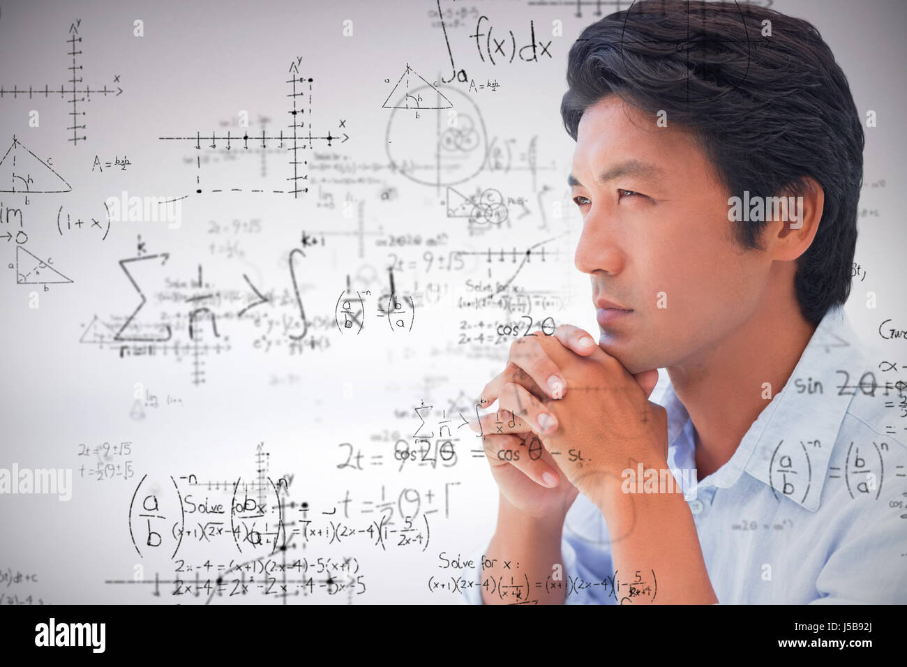 Thinking man with hands together against grey background Stock Photo ...