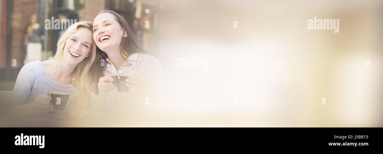 Cheerful young women laughing together outside cafe Stock Photo - Alamy