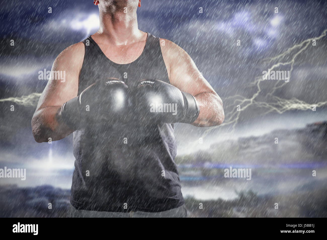 Boxer in boxing gloves laughing against splashing of blue color powder ...