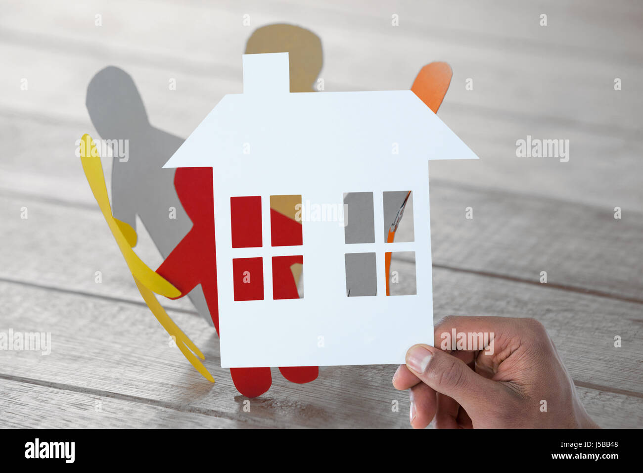 Close up of multi colored paper cut out figures forming circle on ...