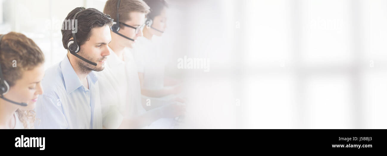 Customer service agents working in office Stock Photo - Alamy