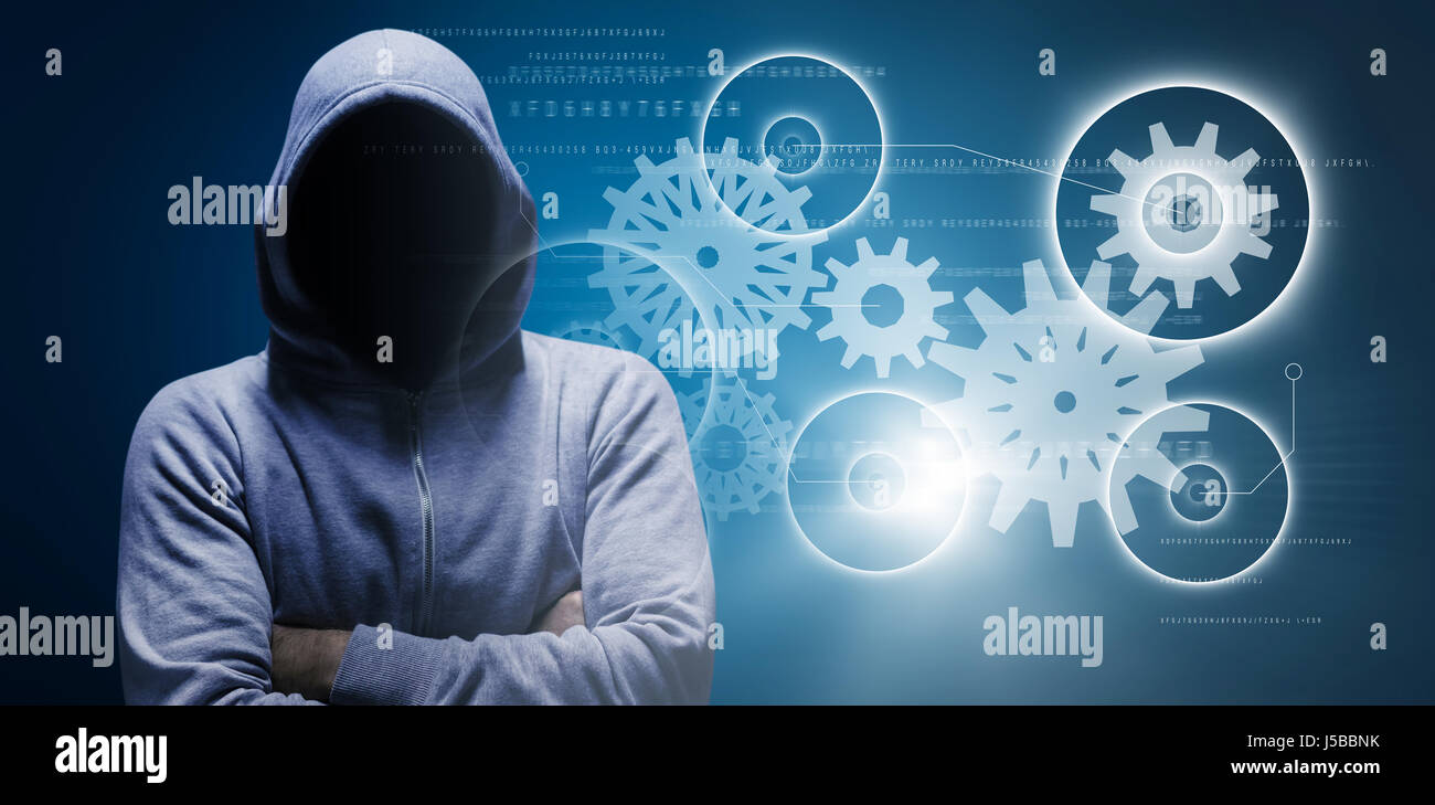 Hacker standing with arms crossed against blue background with vignette ...