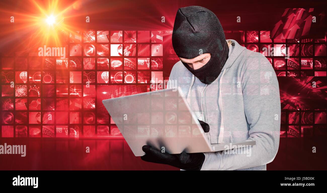 Digital composite of Hacker wearing monkey cap while using laptop Stock ...