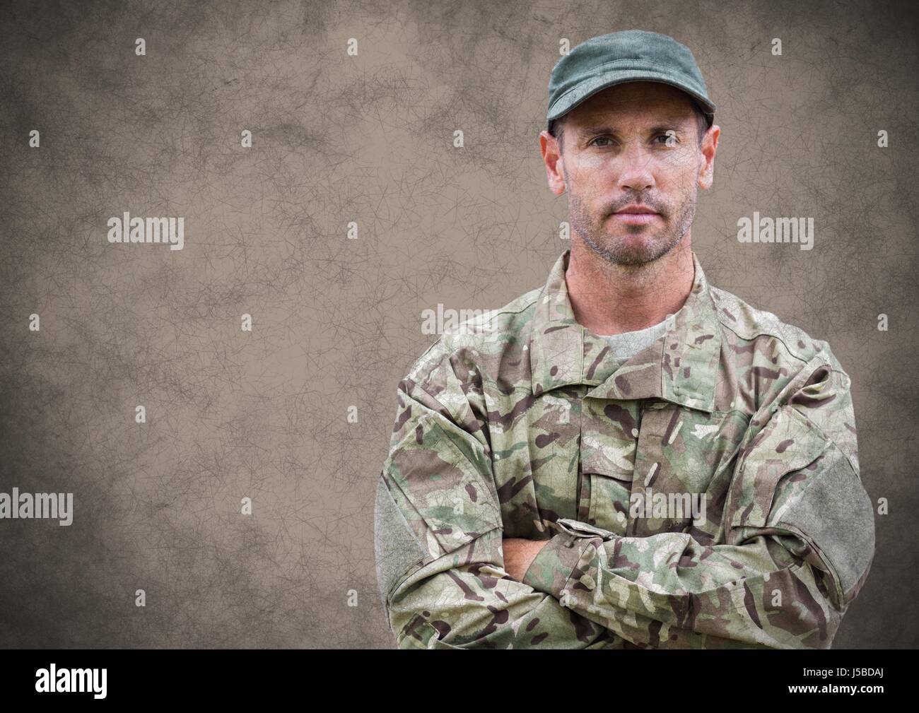 Digital composite of Soldier arms folded against brown background with ...