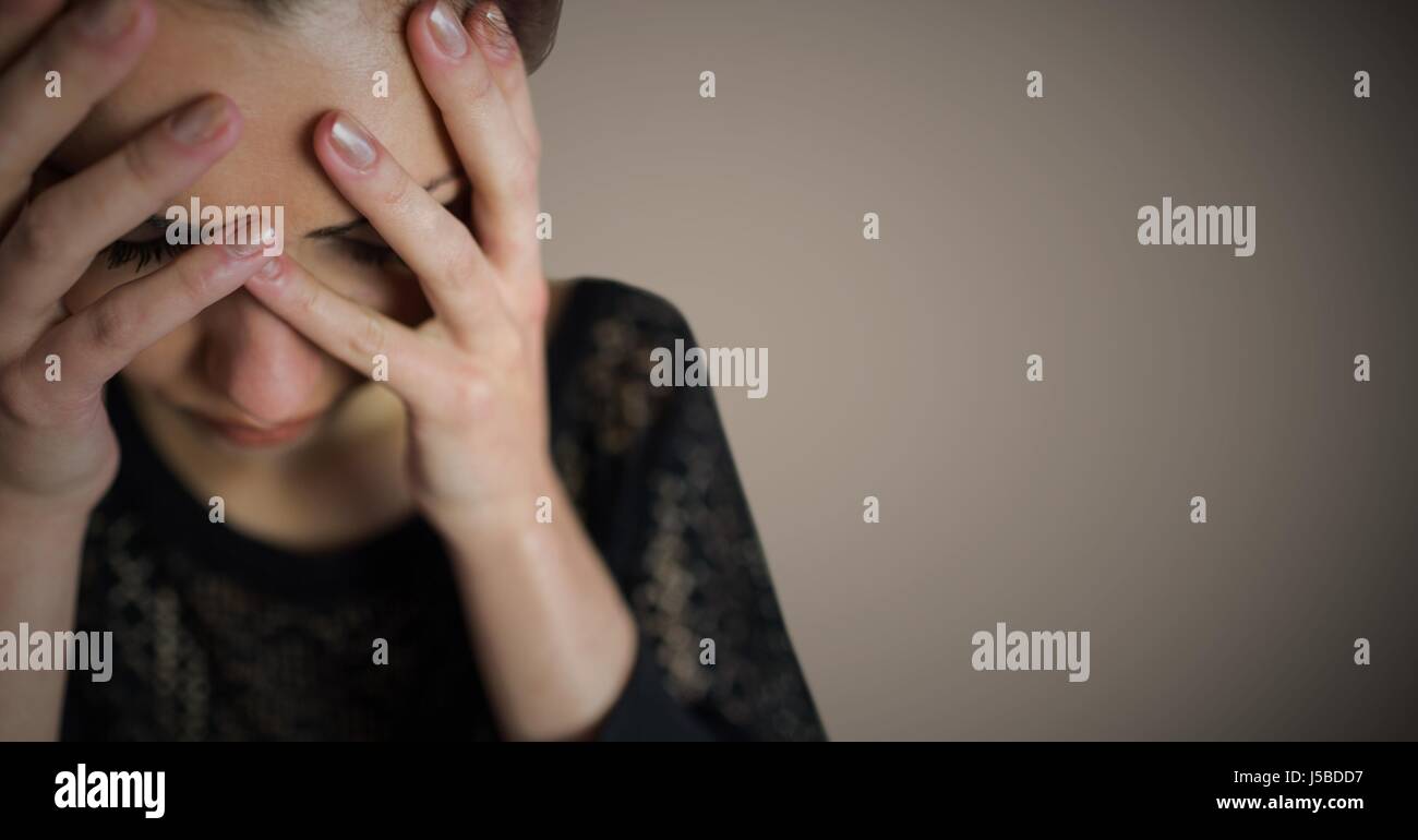 Digital composite of Woman hands over face against brown background ...