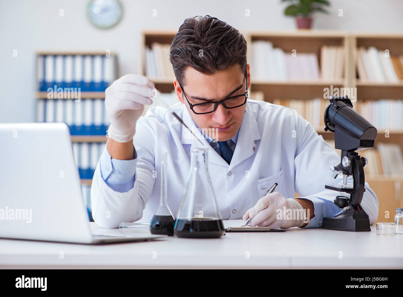 Chemical engineer working on oil samples in lab Stock Photo - Alamy