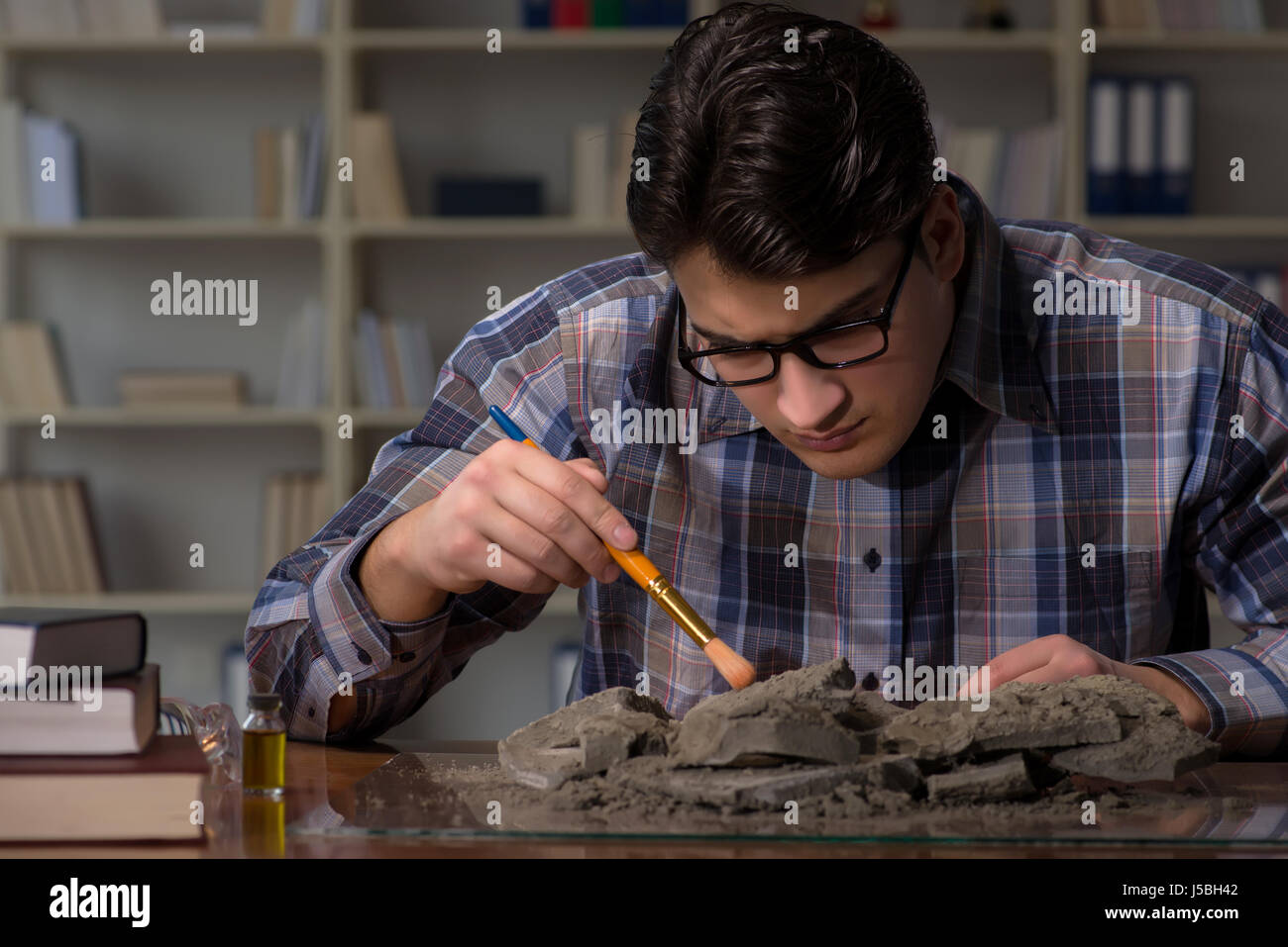 Archeologist working late night in office Stock Photo - Alamy