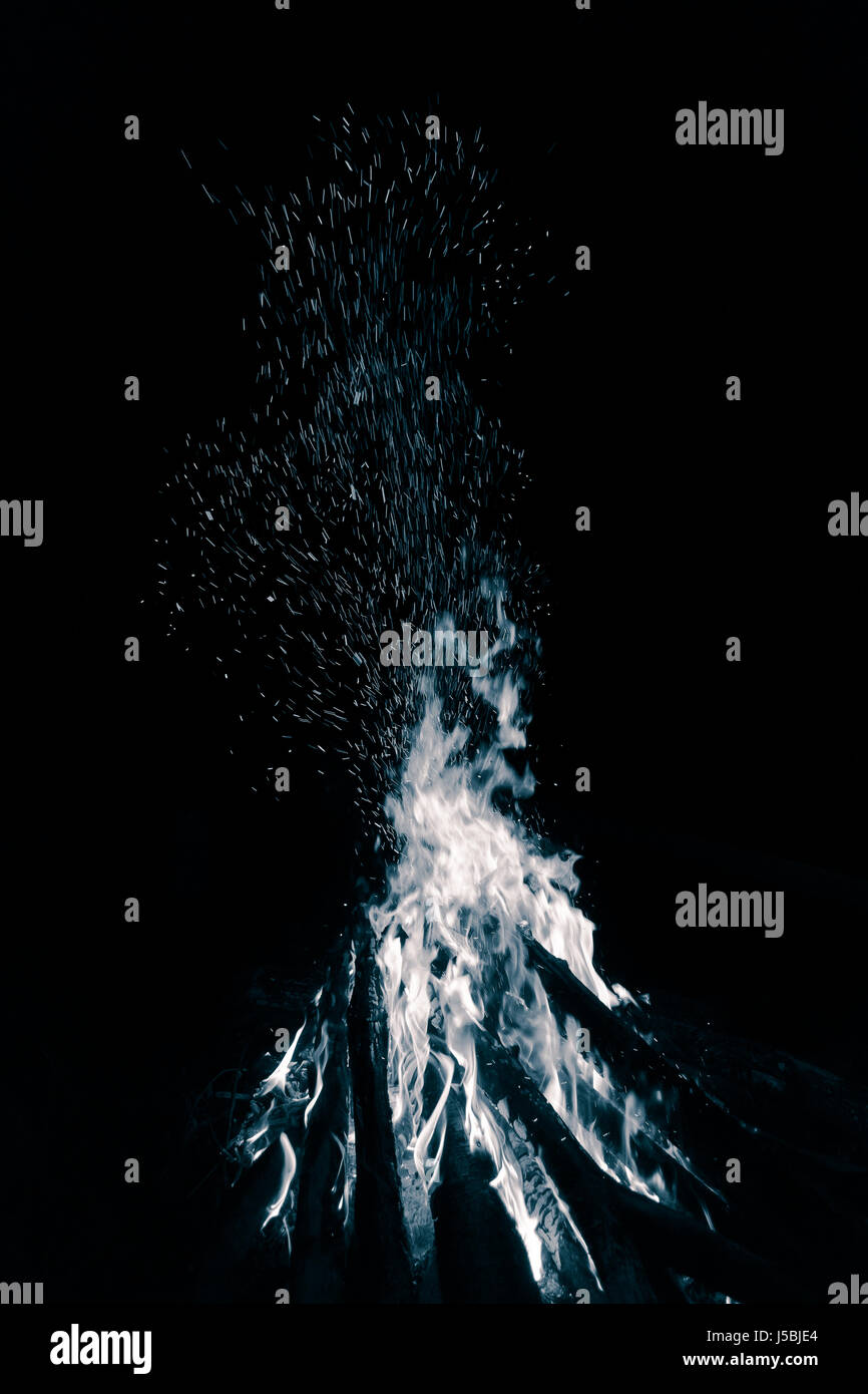Blue bonfire with flying sparks isolated on black Stock Photo - Alamy