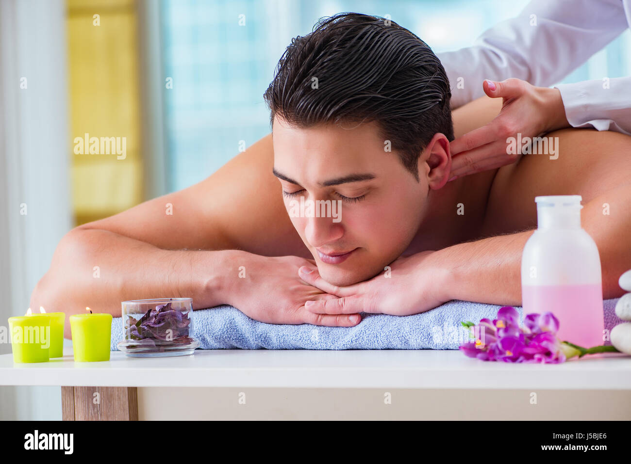 Handsome man in spa massage concept Stock Photo - Alamy