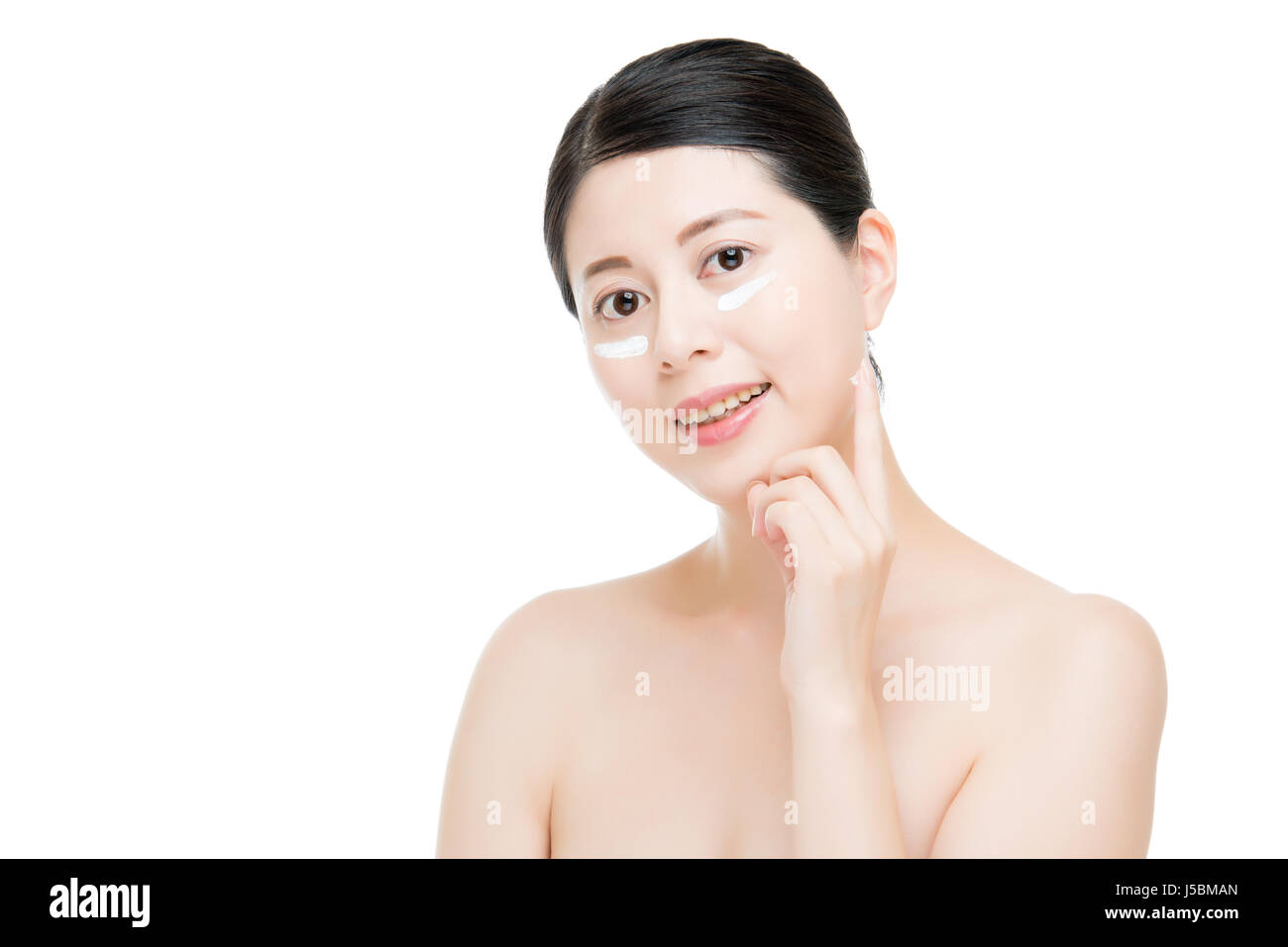 beautiful mixed race asian chinese model applying moisturizing cosmetic ...