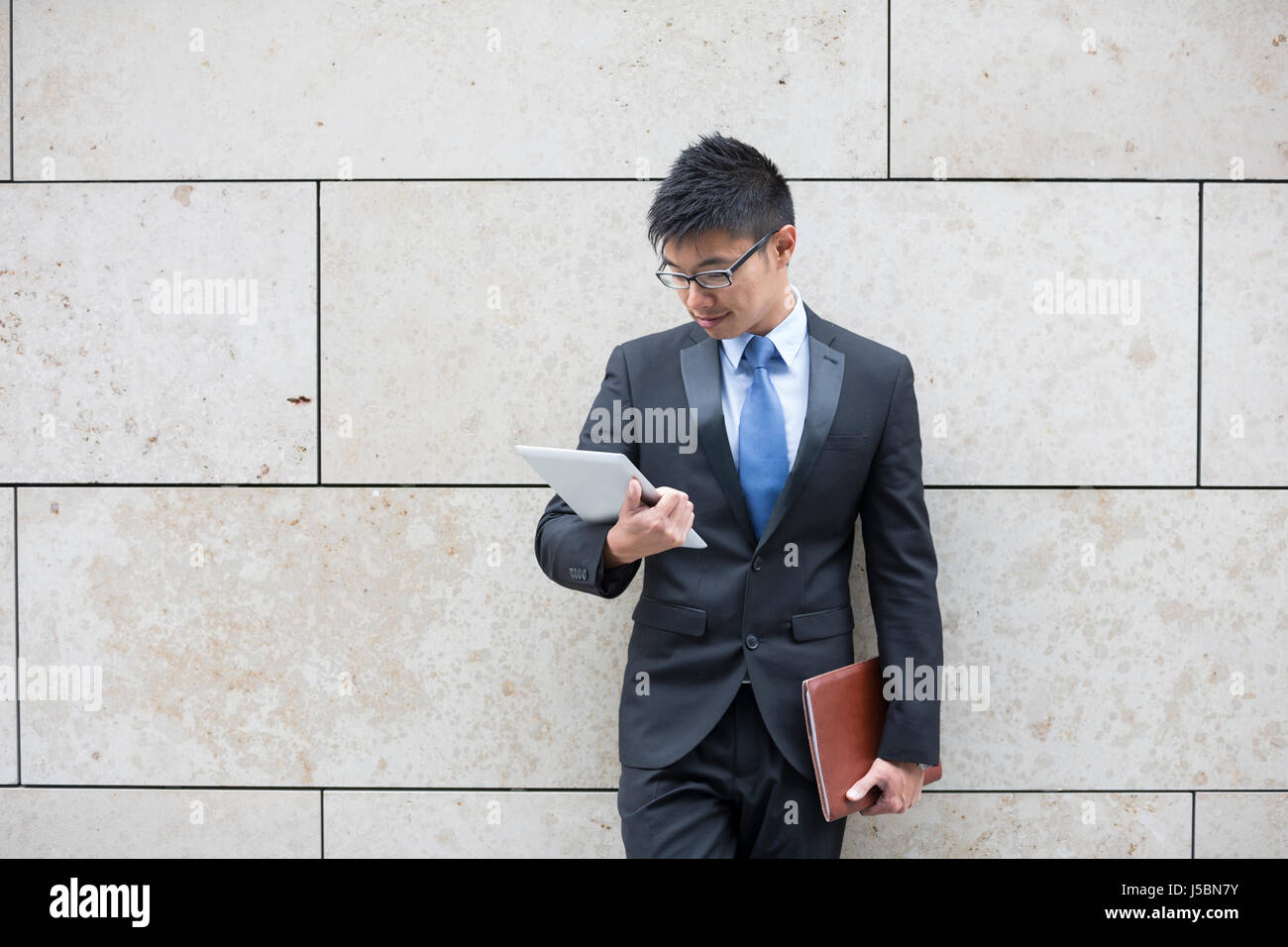 Portrait of a Chinese man with a tablet computer. Asian business man ...
