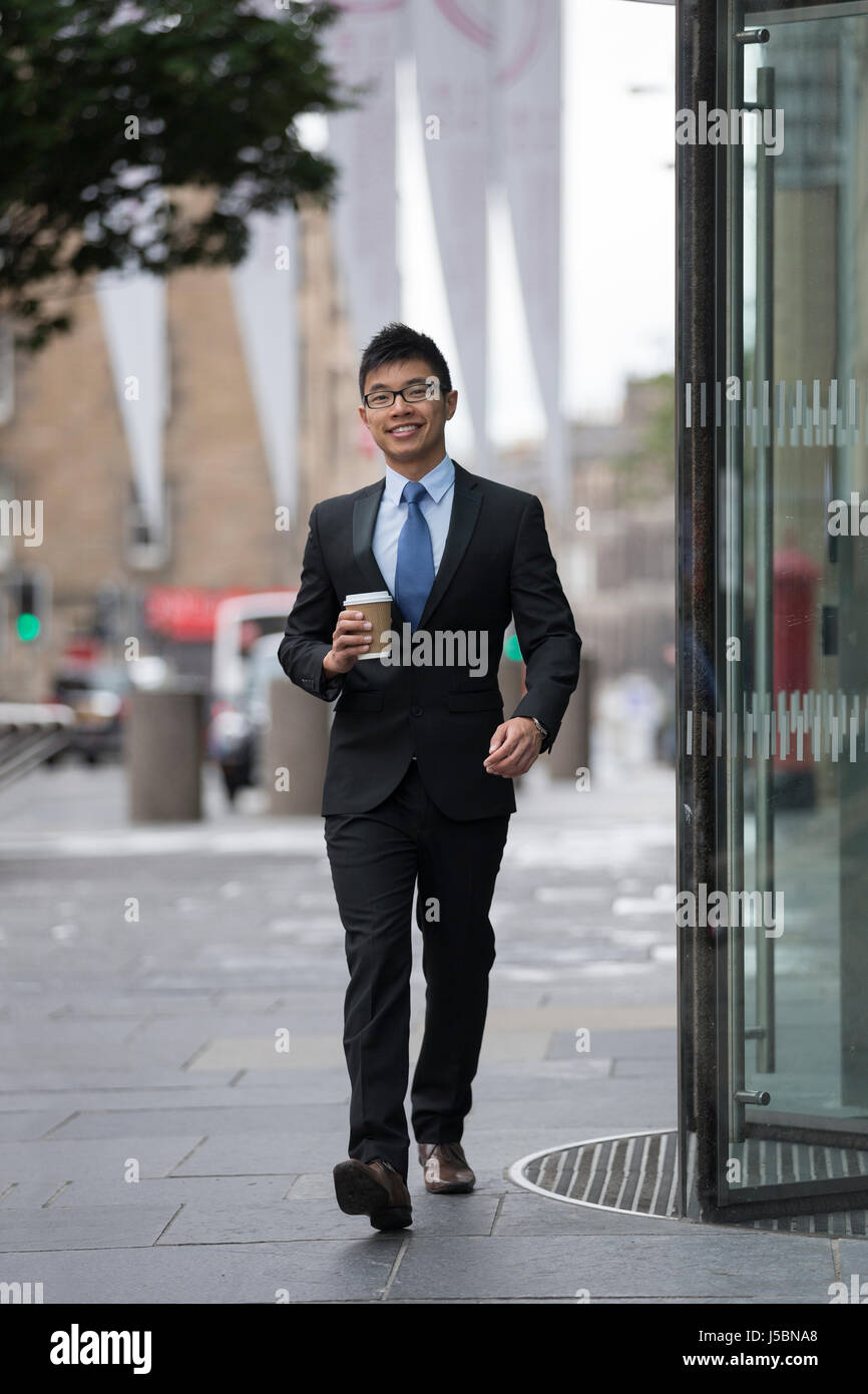 Portrait of a Chinese businessman outside modern office building. Asian ...