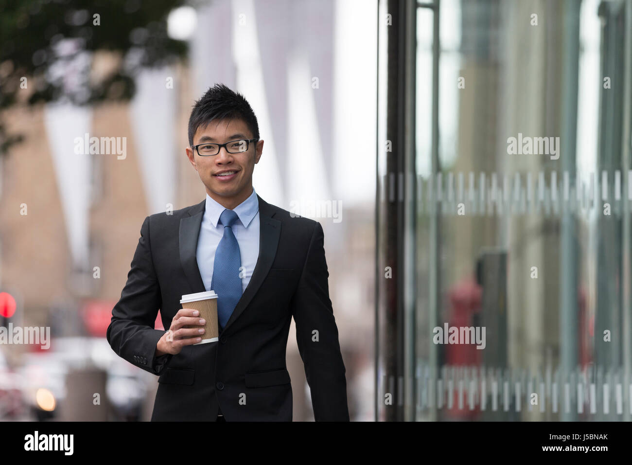 Portrait of a Chinese businessman outside modern office building. Asian ...