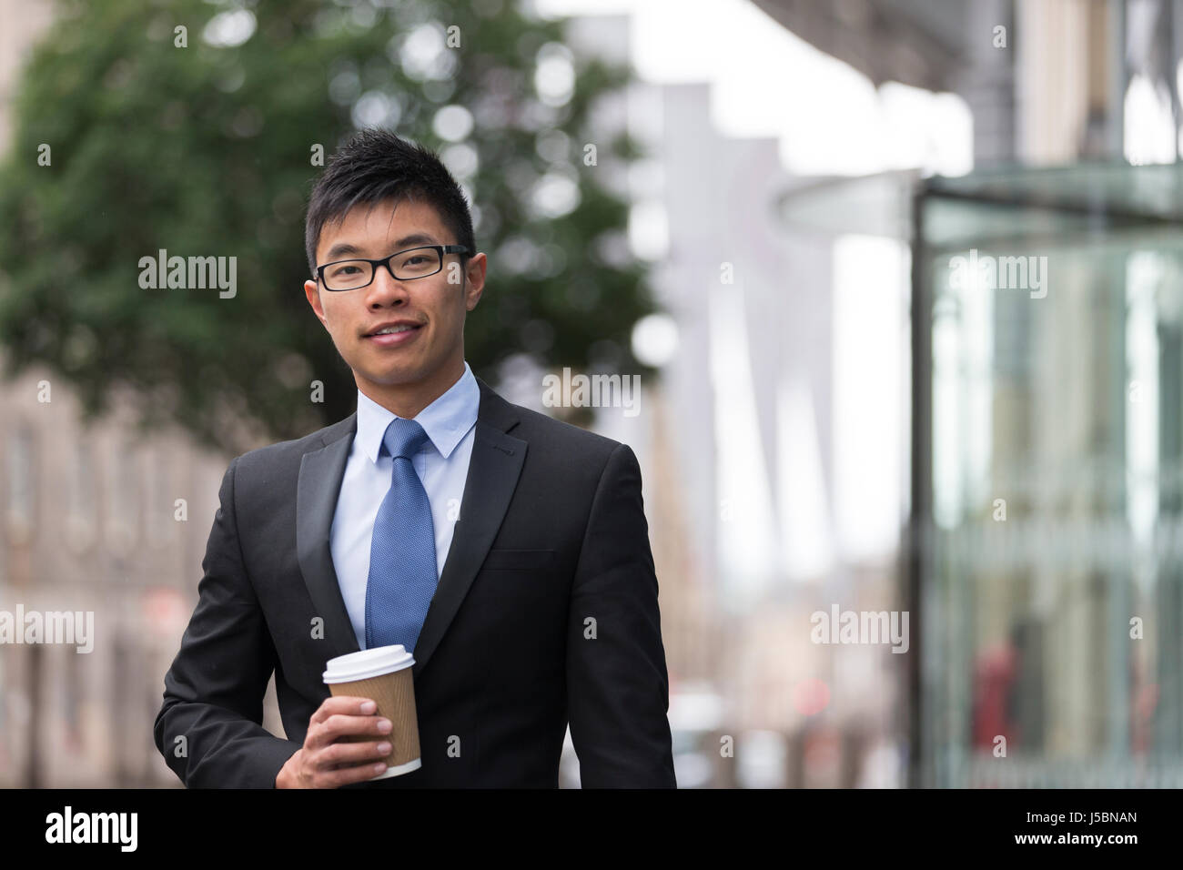 Portrait of a Chinese businessman outside modern office building. Asian ...