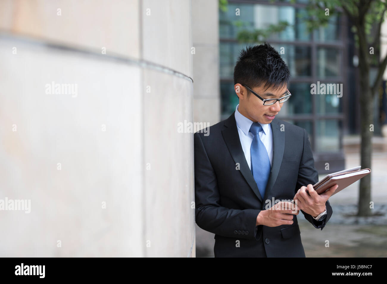 Portrait of a Chinese man with a tablet computer. Asian business man ...