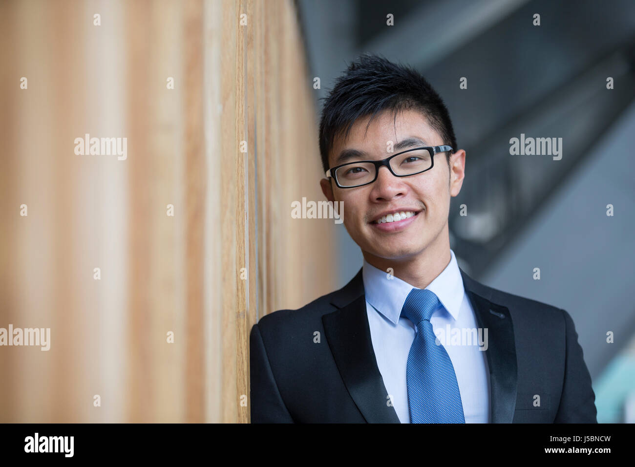 Portrait of a Chinese businessman outside modern office building. Asian ...