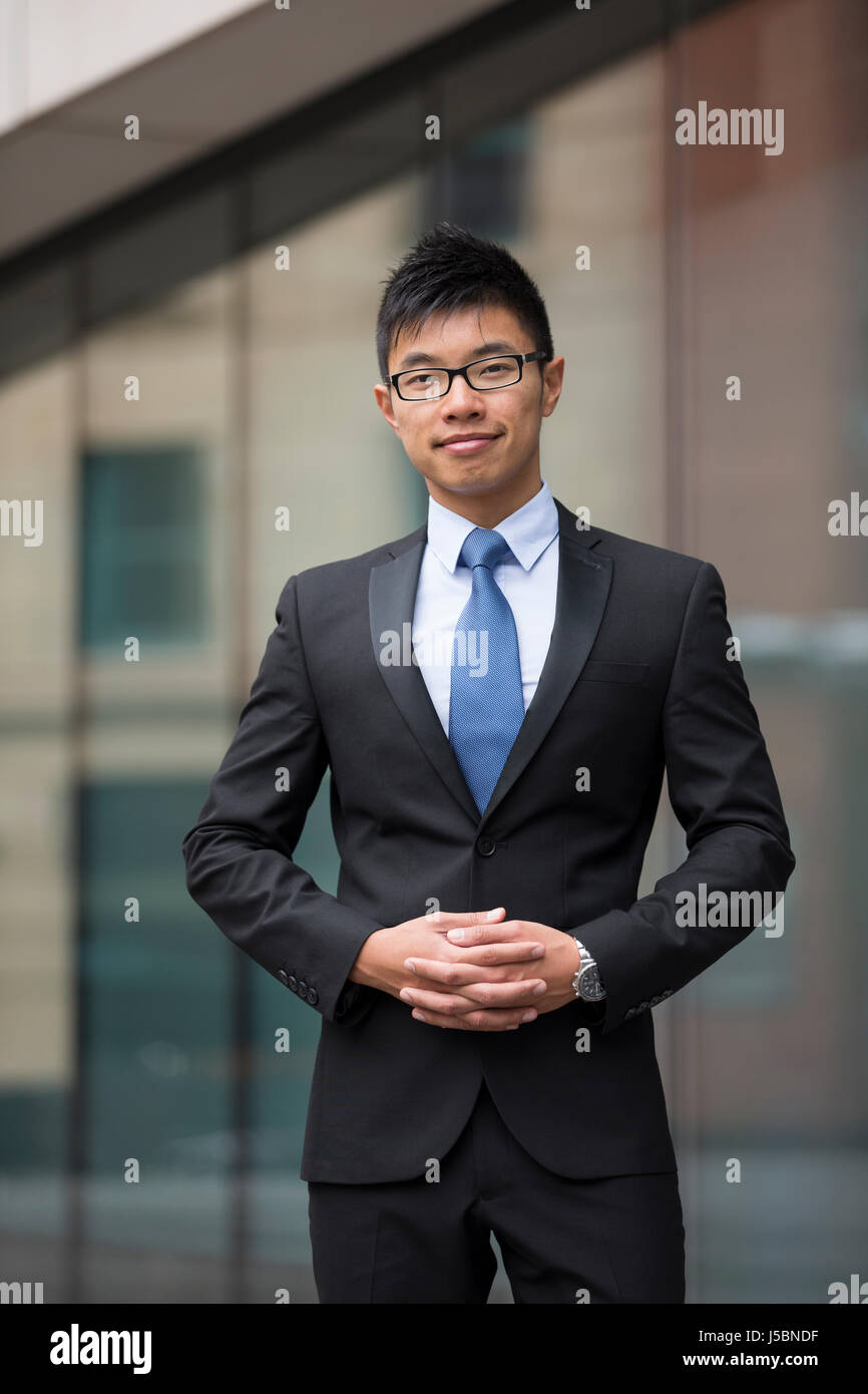 Portrait of a Chinese businessman outside modern office building. Asian ...