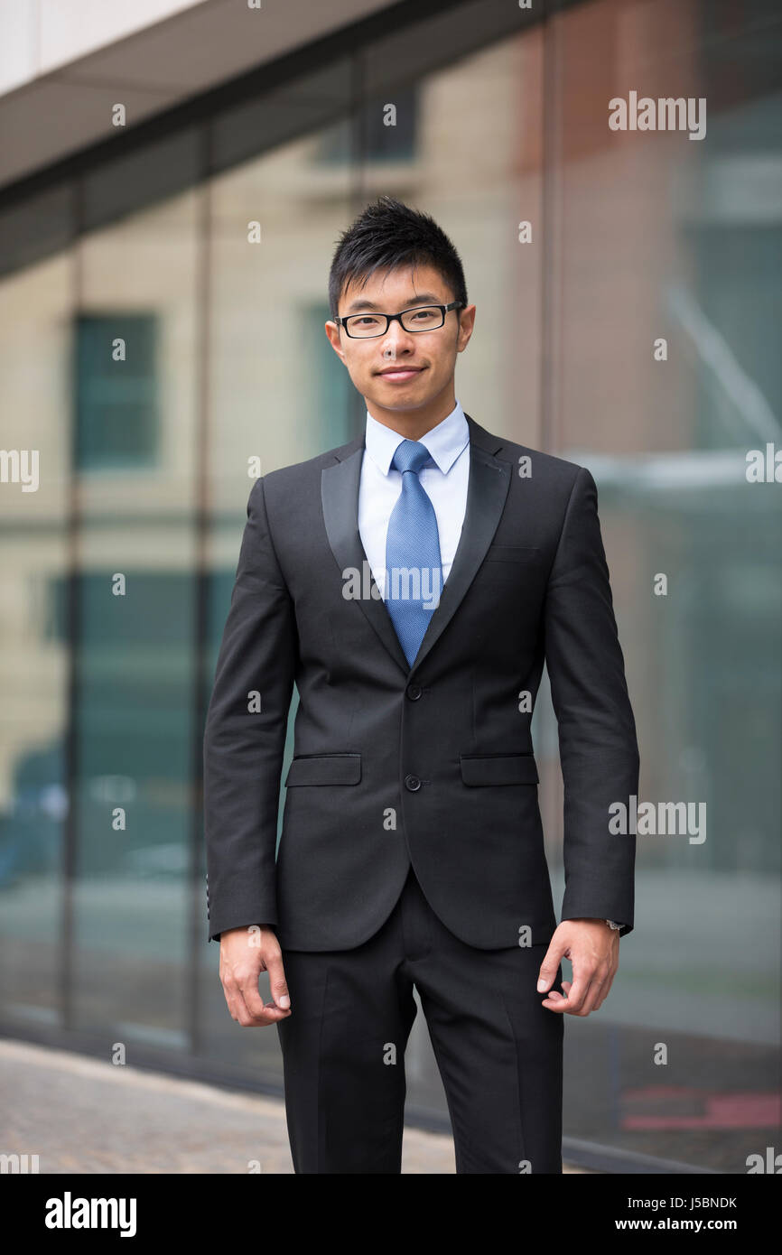 Portrait of a Chinese businessman outside modern office building. Asian ...