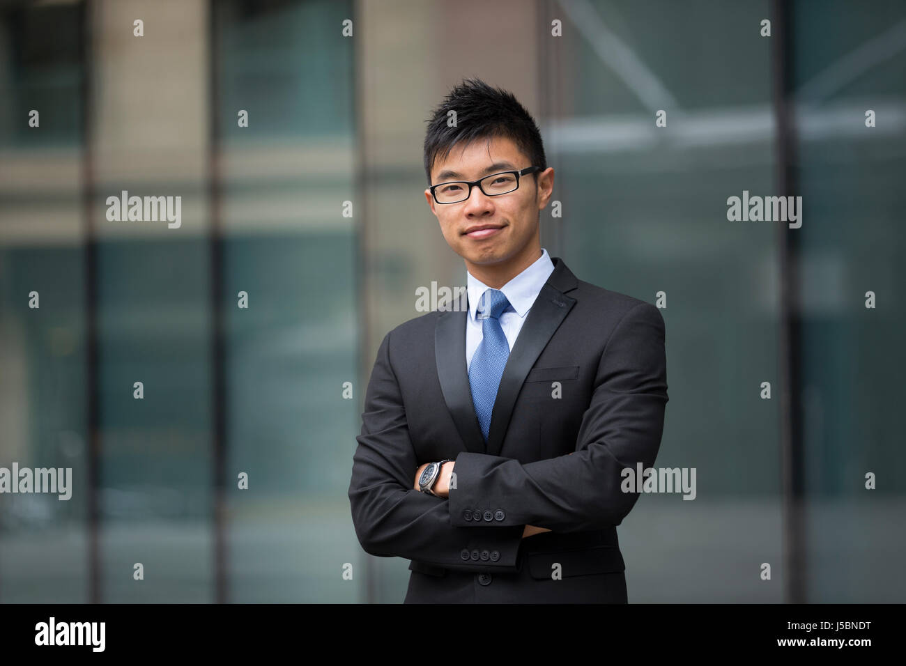 Portrait of a Chinese businessman outside modern office building. Asian ...