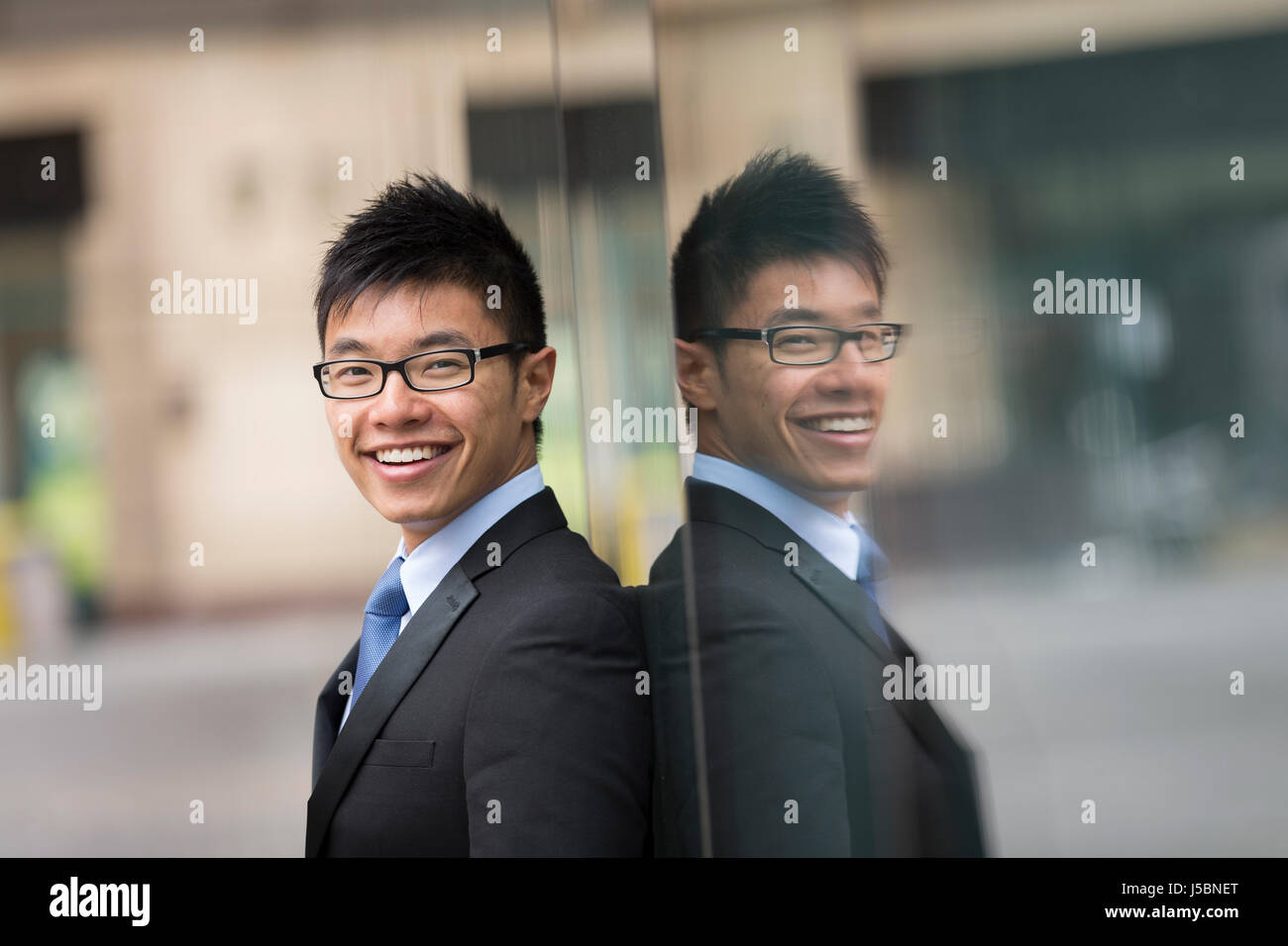 Portrait of a Chinese businessman outside modern office building. Asian ...