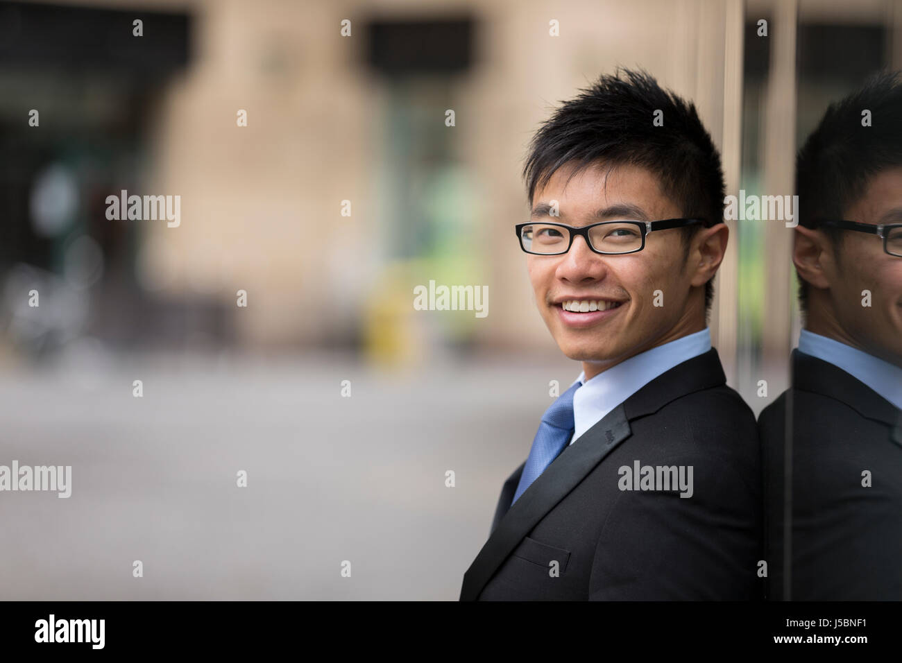 Portrait of a Chinese businessman outside modern office building. Asian ...